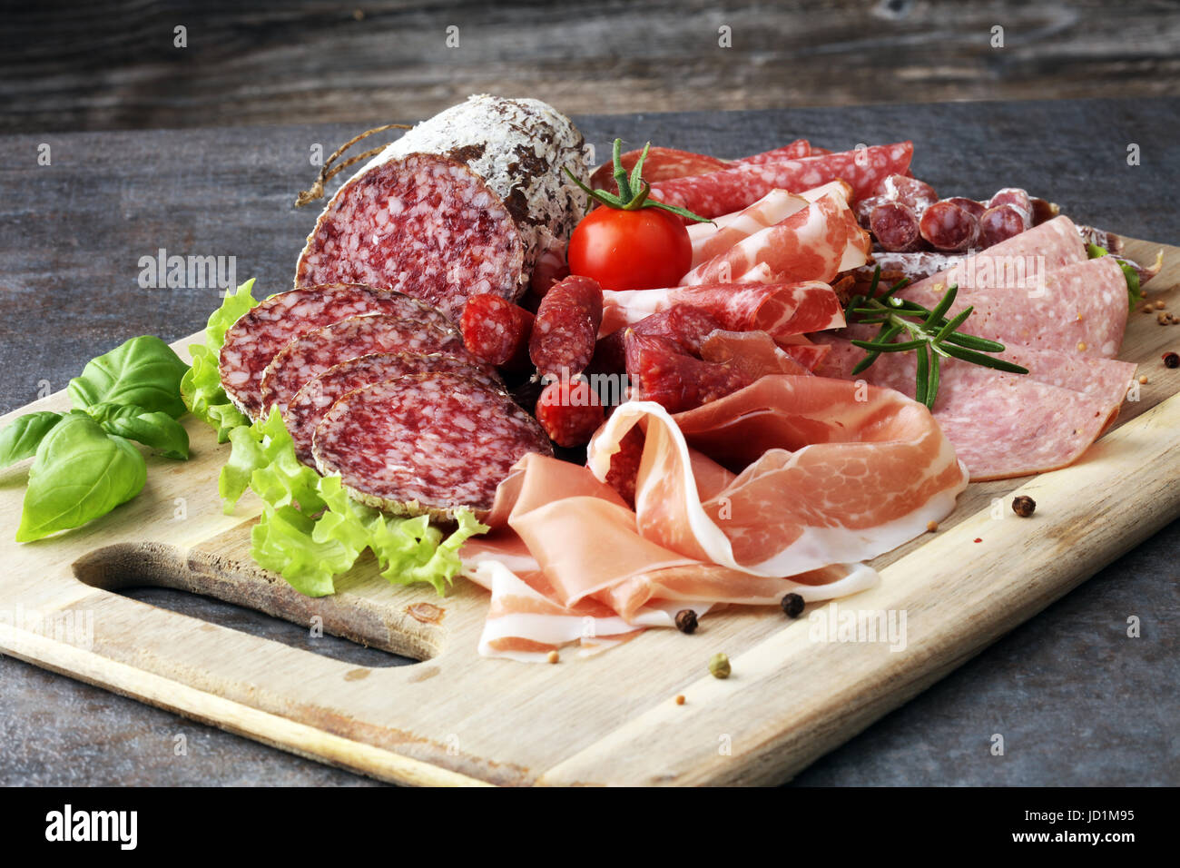 Food tray with delicious salami, pieces of sliced ham, sausage ...