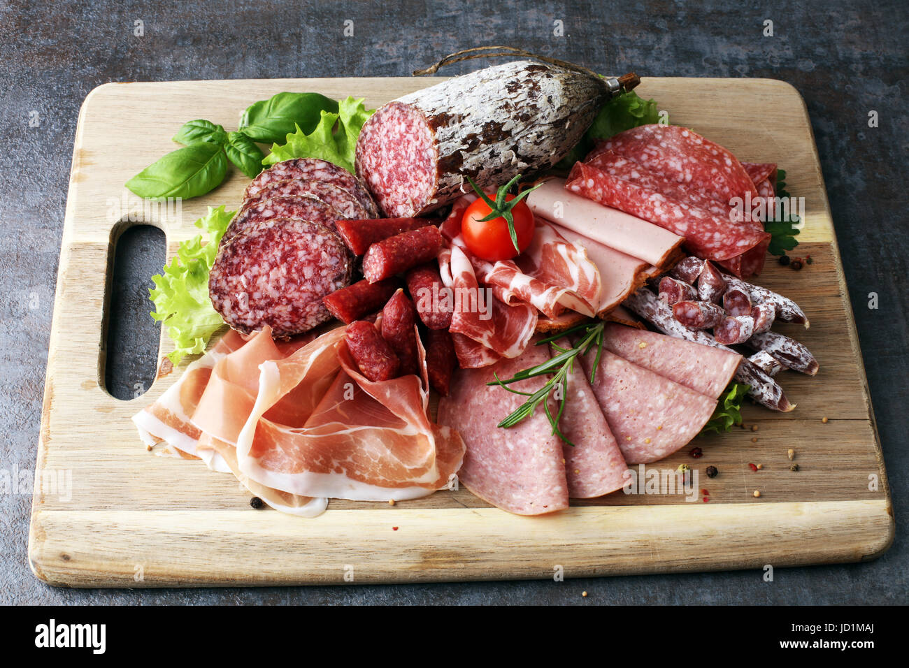 Food tray with delicious salami, pieces of sliced ham, sausage ...