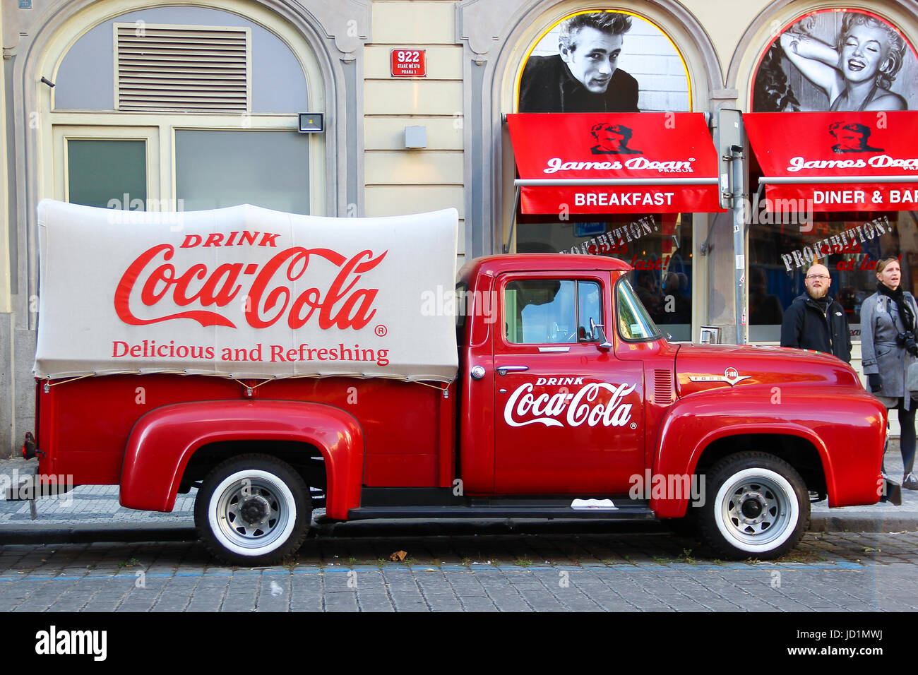 An old renovated red Ford vintage Coca cola truck (pickup) in a parking ...