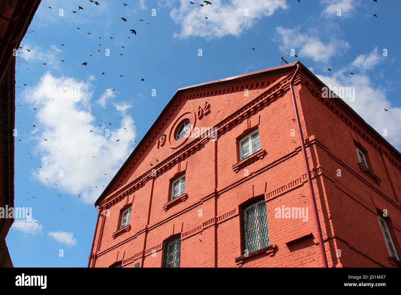 The building of the old watermill of red brick. View from below on a ...