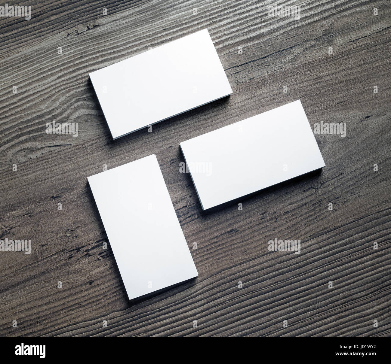 Three piles of blank business cards on wood background. Template for ...
