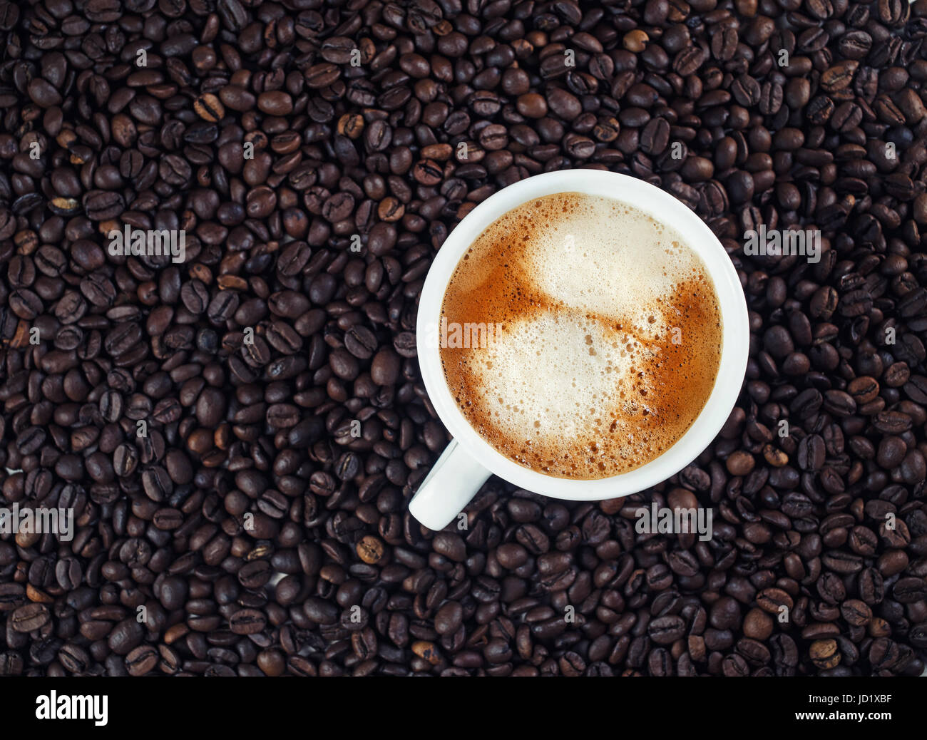 Fresh coffee cup on coffee beans background Stock Photo - Alamy