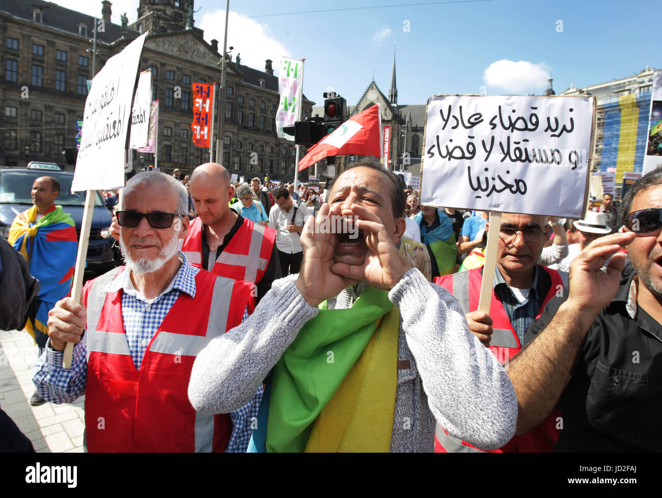 Moroccan immigrant and refugees chant and hold posters in solidarity ...