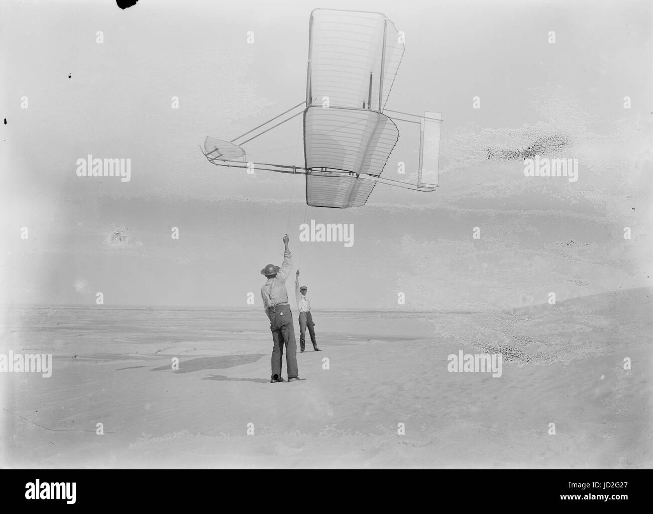 Side view of Dan Tate, left, and Wilbur, right, flying the 1902 glider ...