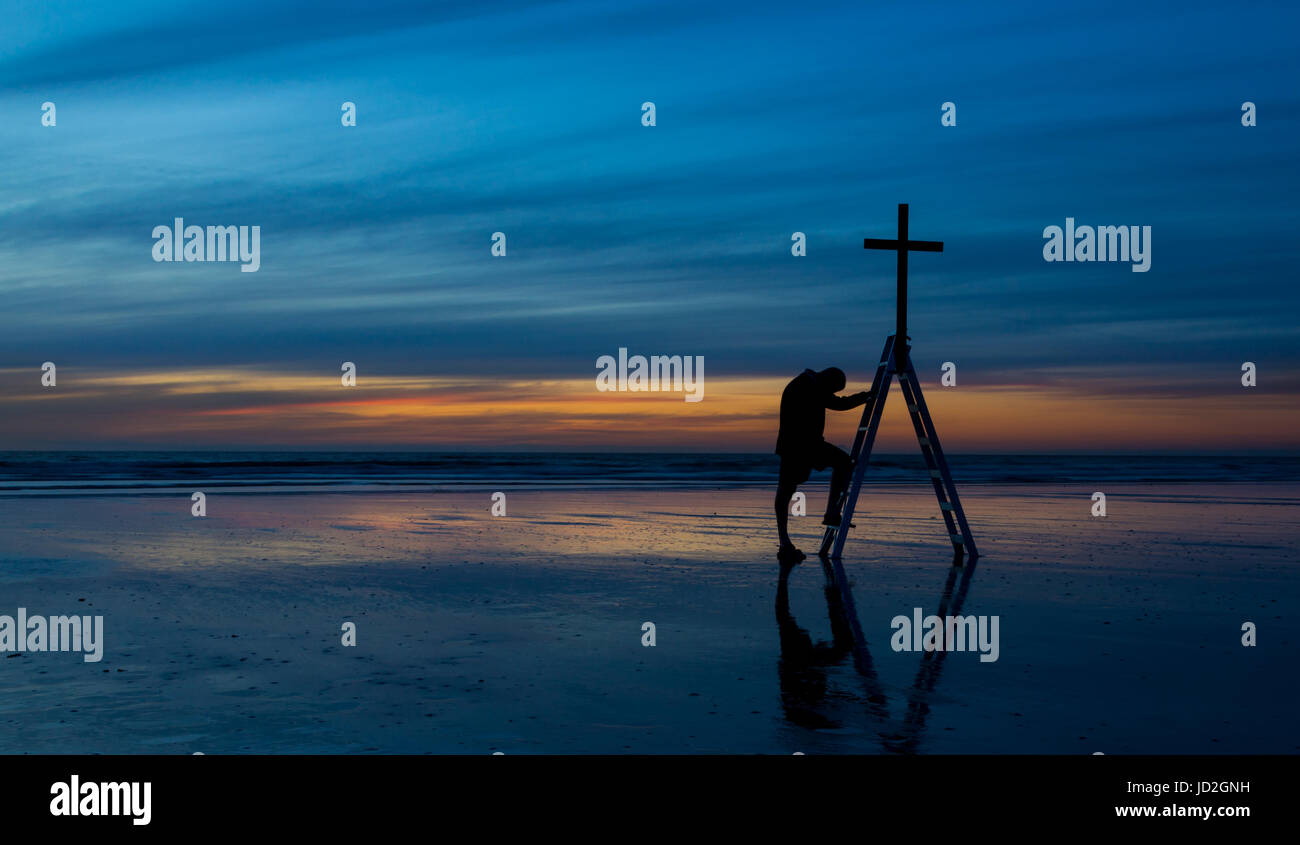 Man making a step of faith to the cross of salvation Stock Photo - Alamy