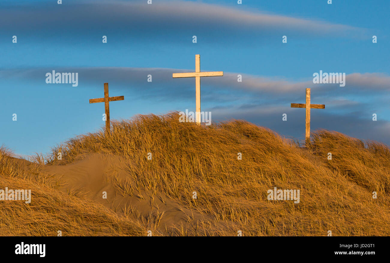 Three crosses on a sand dune that has grass plant on it Stock Photo - Alamy