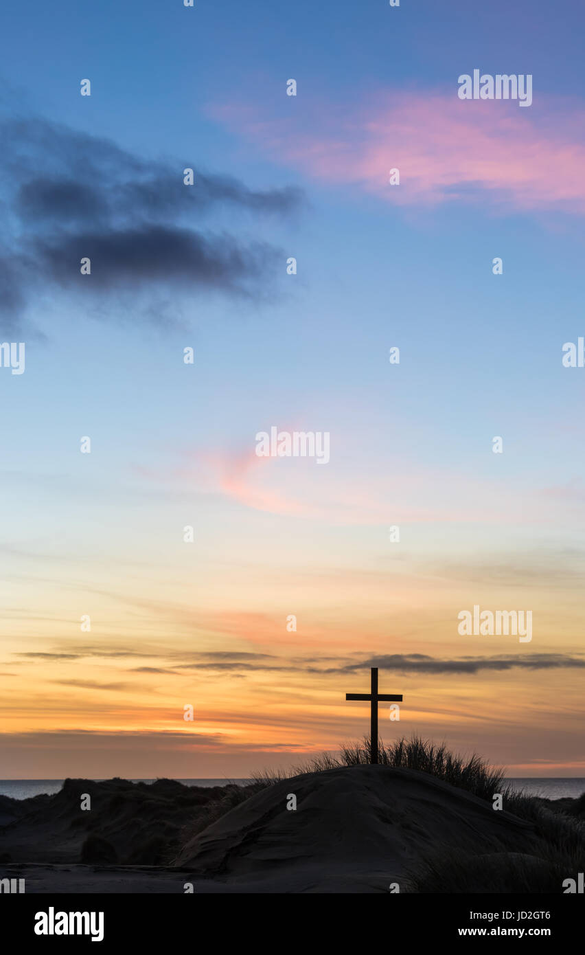 Cross on a sand dune with a wonderful sunset sky in the background ...