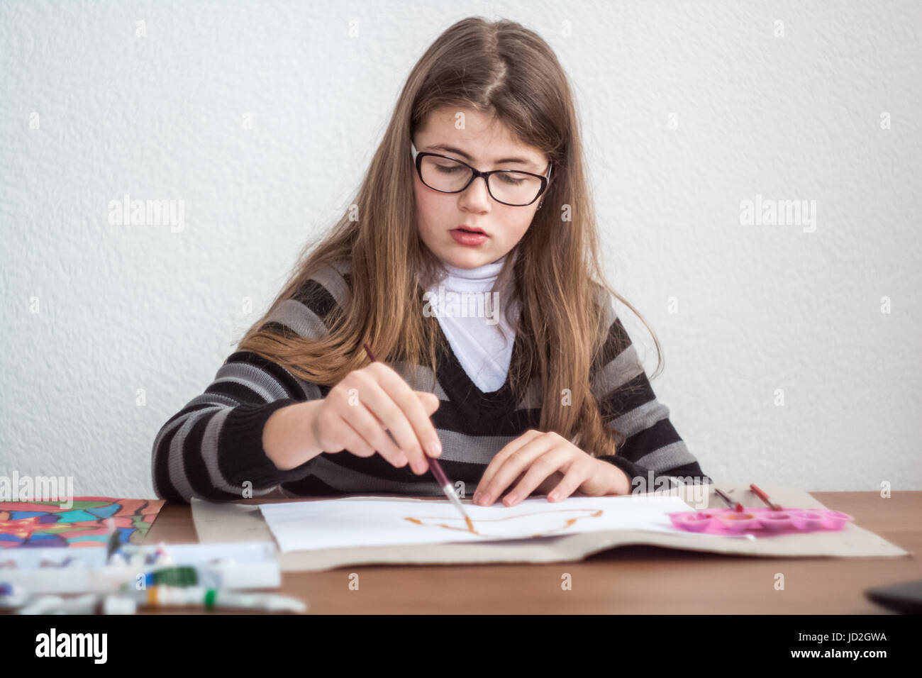 Little girl painting with paintbrush and colorful paints Stock Photo ...