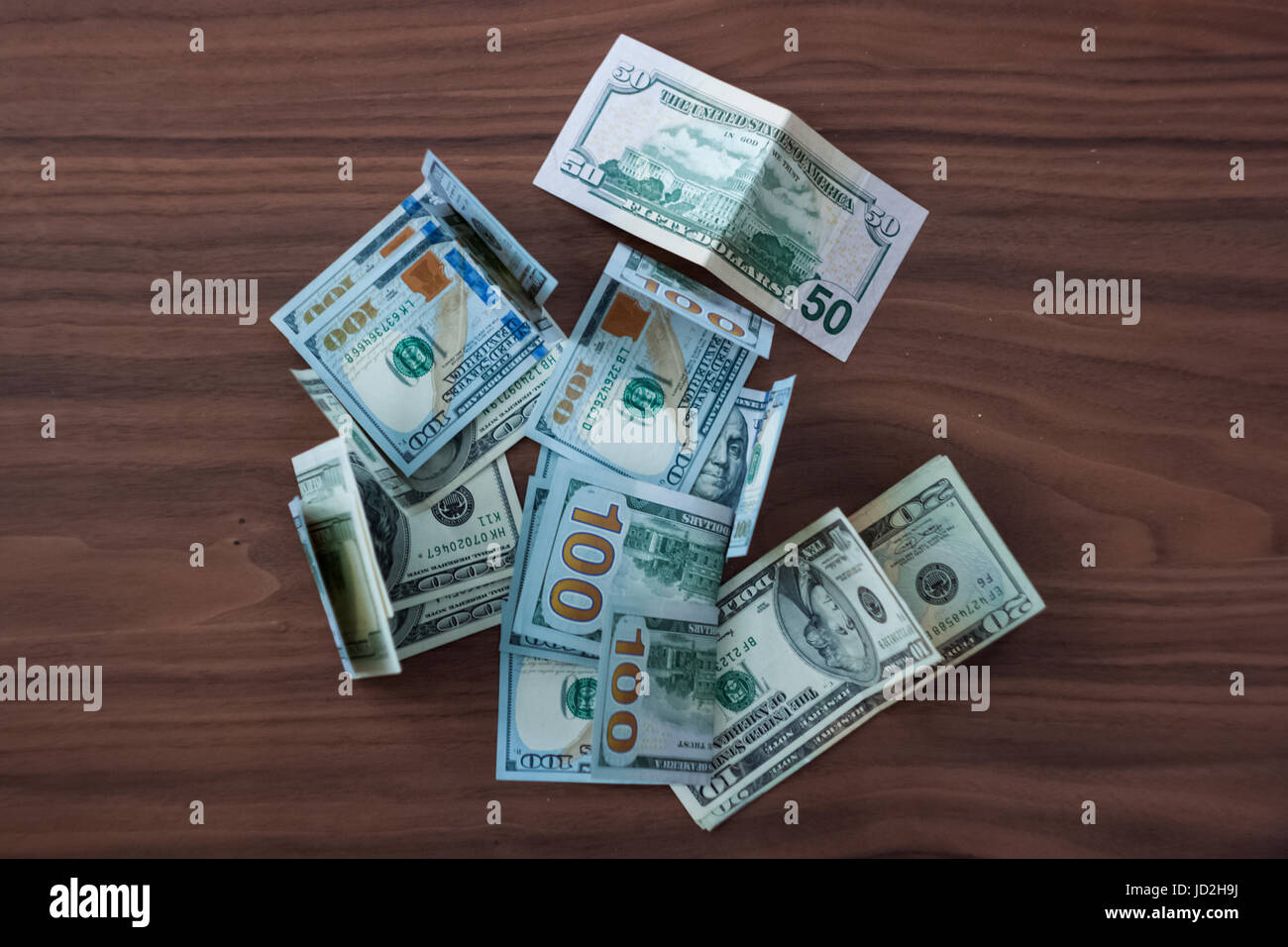 Paper money is scattered everywhere, with the background wood below ...