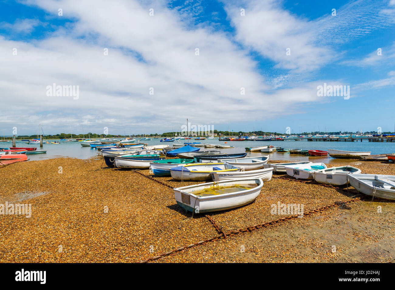 Rowing boats moored on the shoreline at West Itchenor, a small village ...
