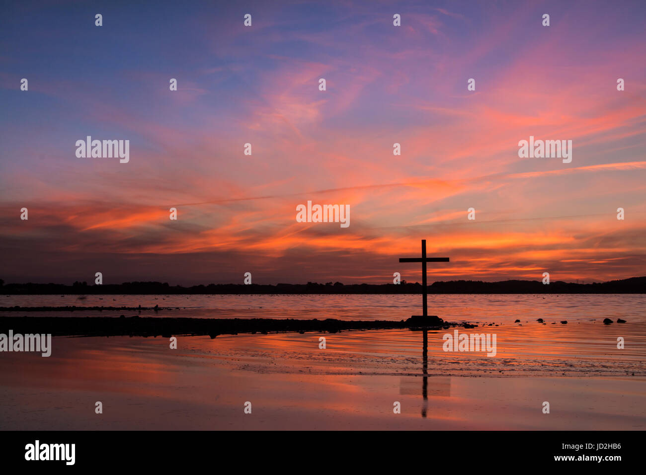 Lake at sunset of wonderful color, with a cross in it Stock Photo - Alamy