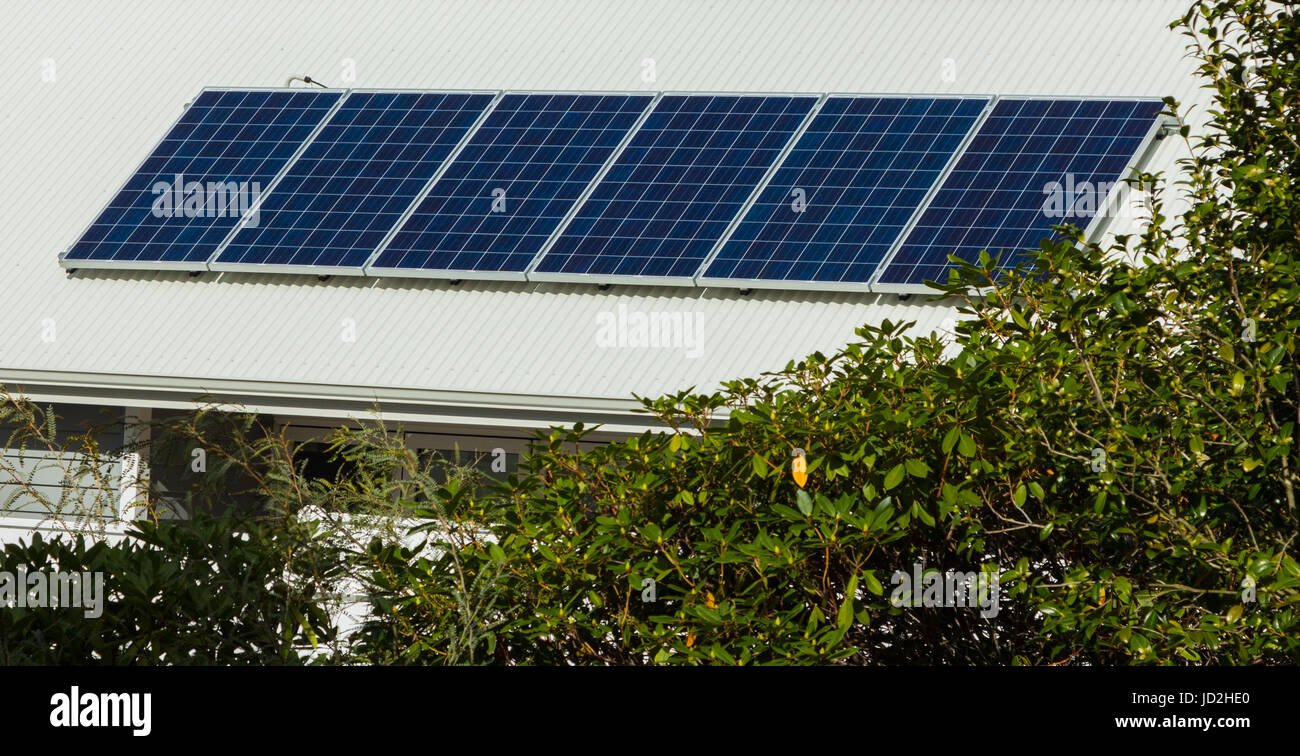 Six solar panels on a white roof top Stock Photo - Alamy