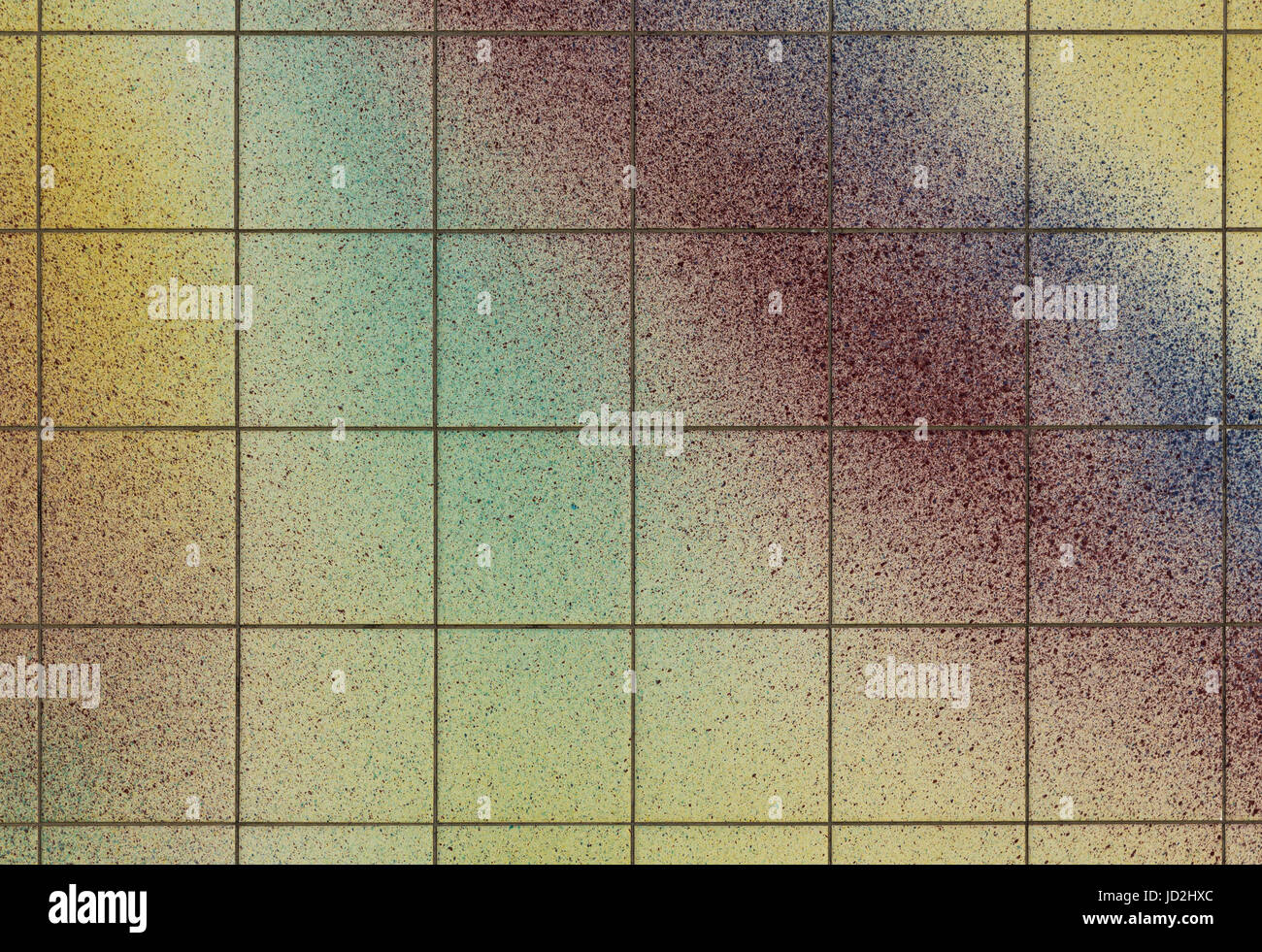 Spray of color on a square tile wall Stock Photo - Alamy