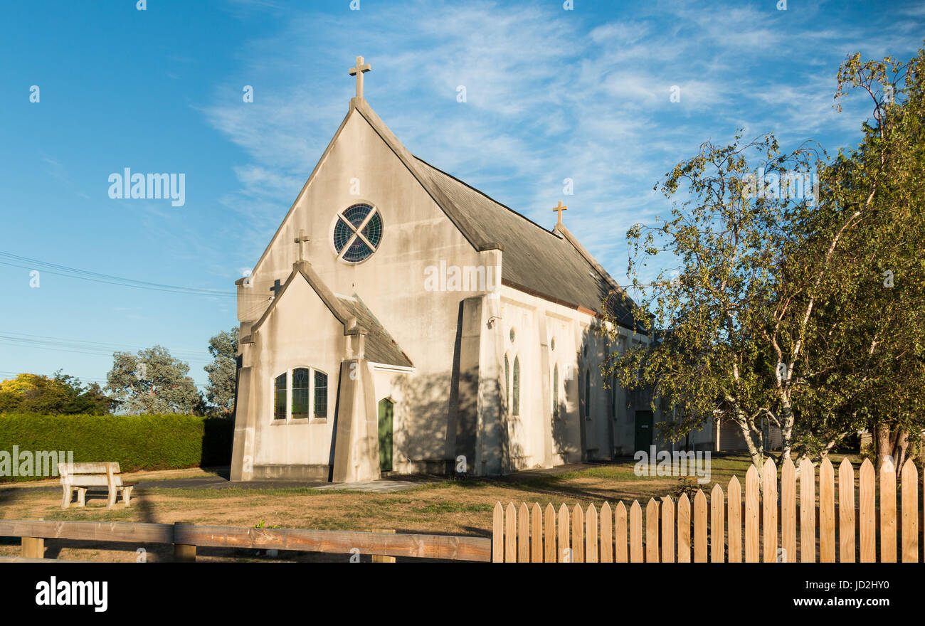 One very grey looking church, with a seat in front of it Stock Photo ...