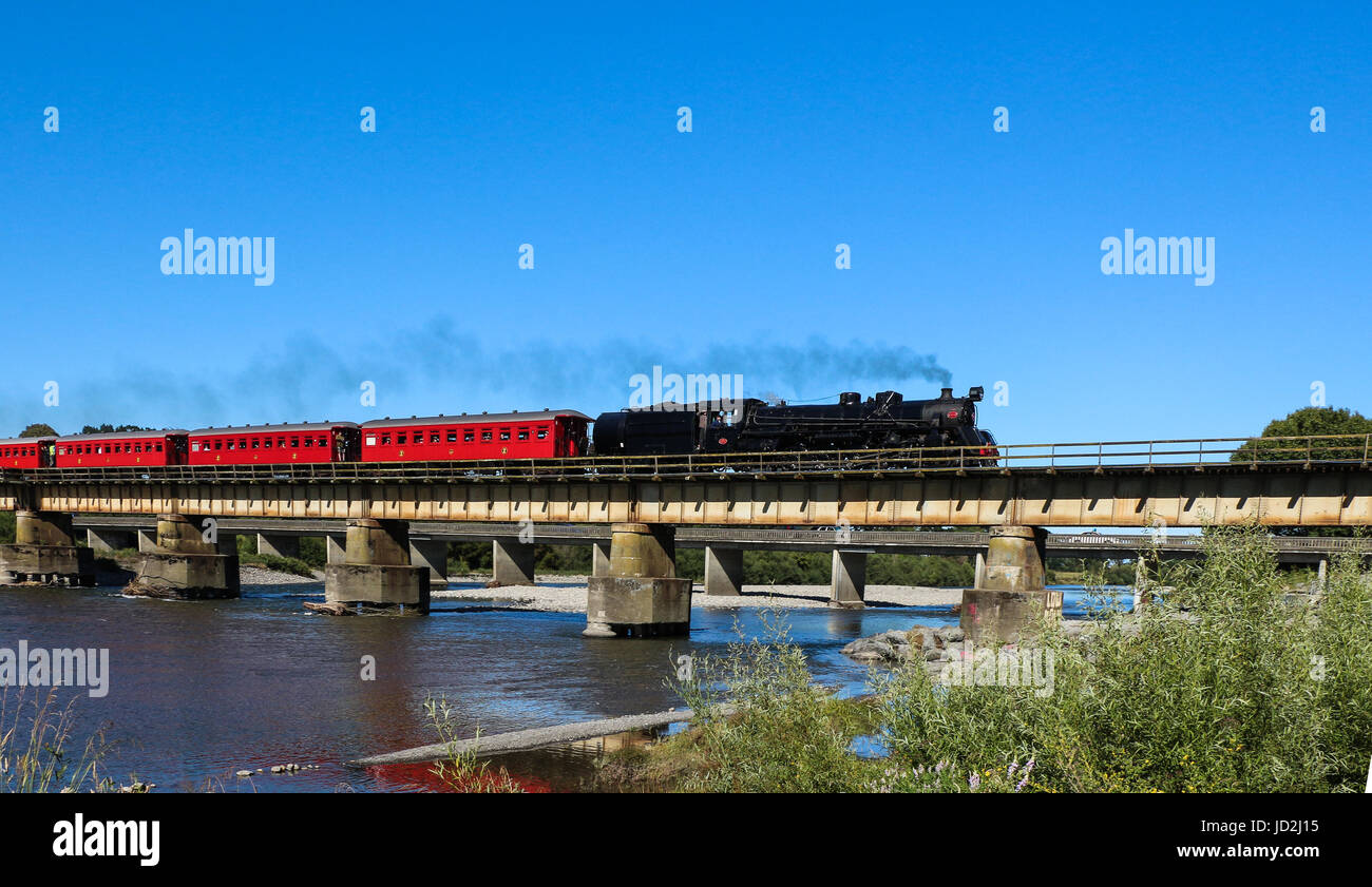 Steam train cross over a railway bridge Stock Photo - Alamy