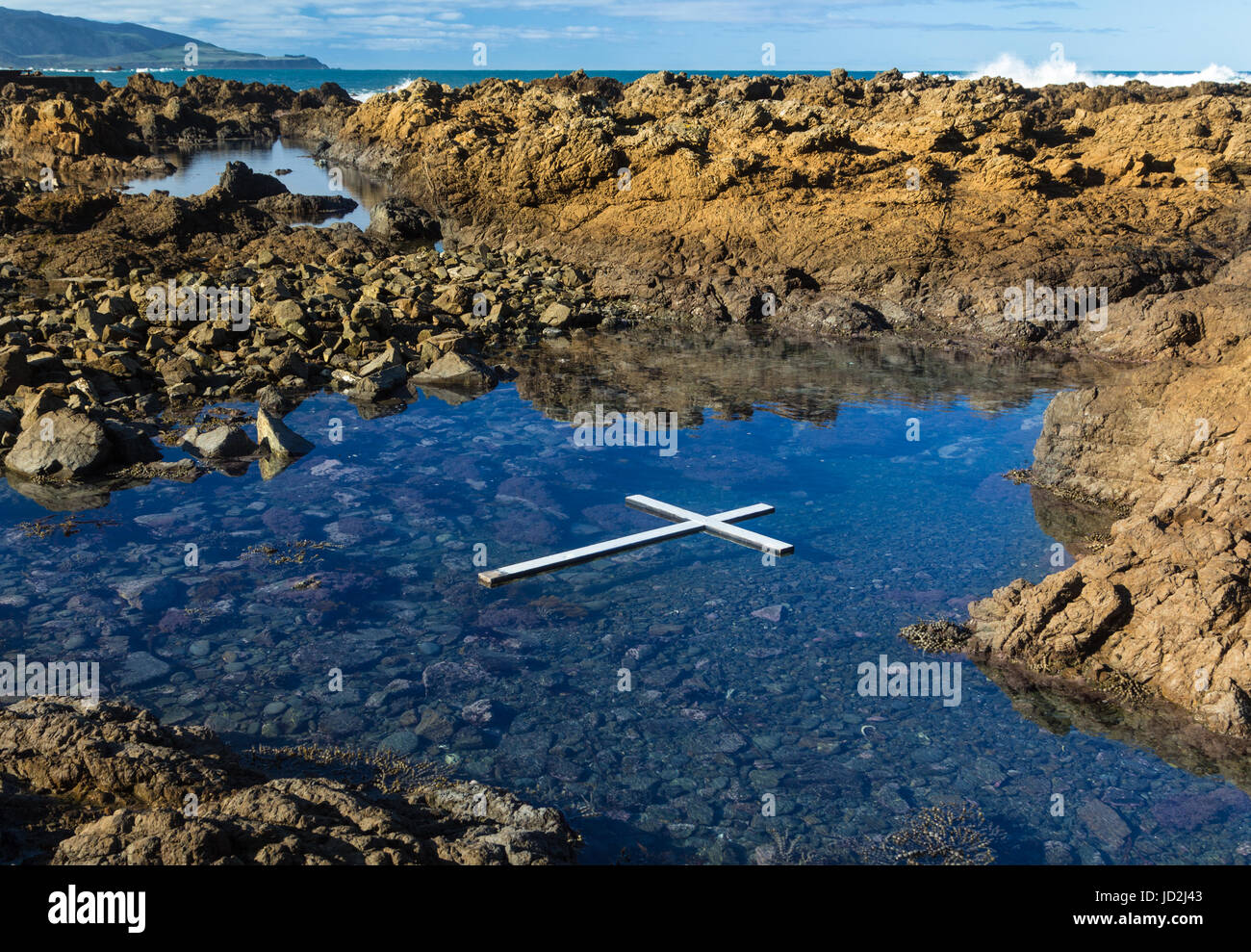 White cross floating on clear water Stock Photo - Alamy