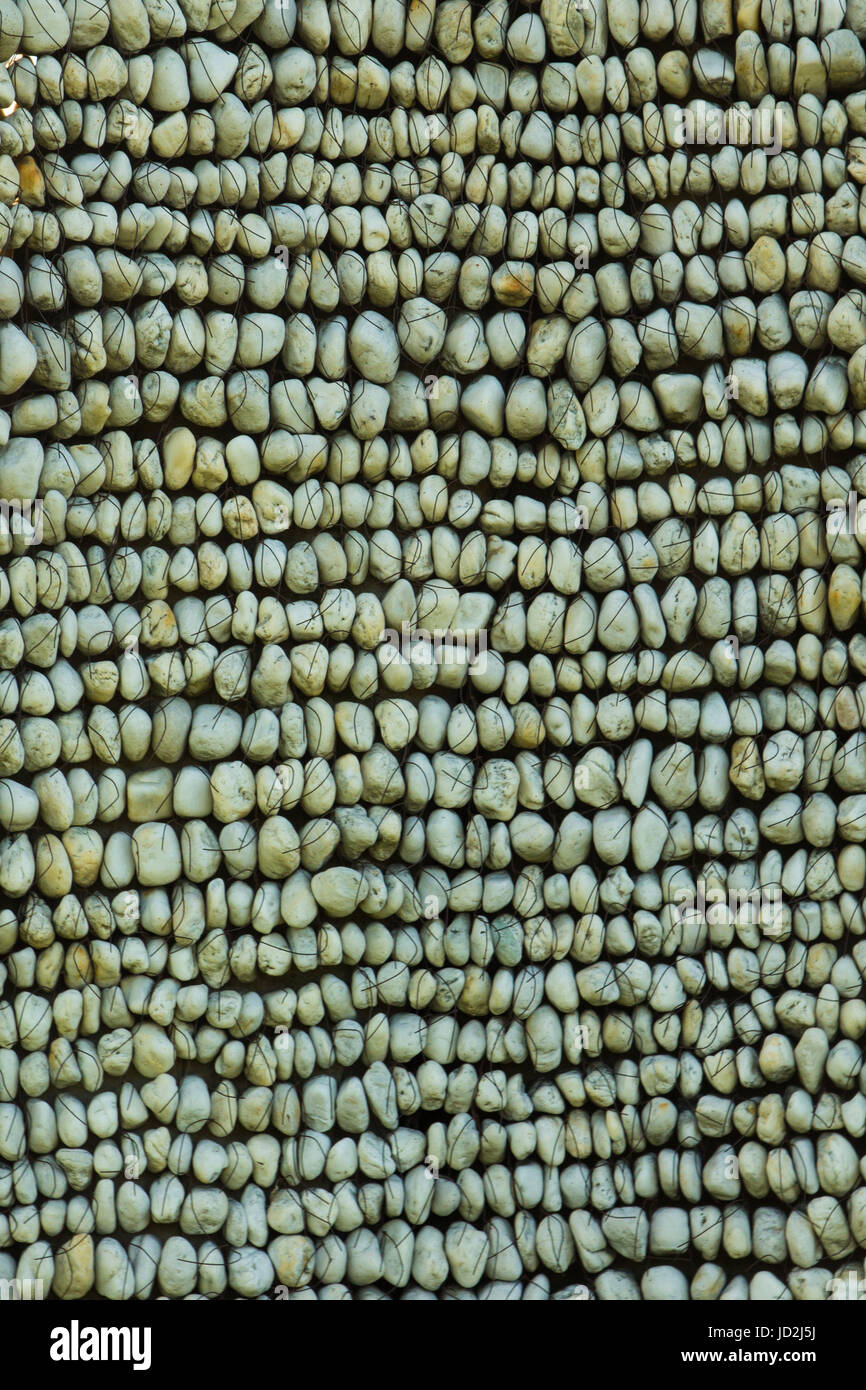Stones made into a net wall with a lot of string Stock Photo - Alamy