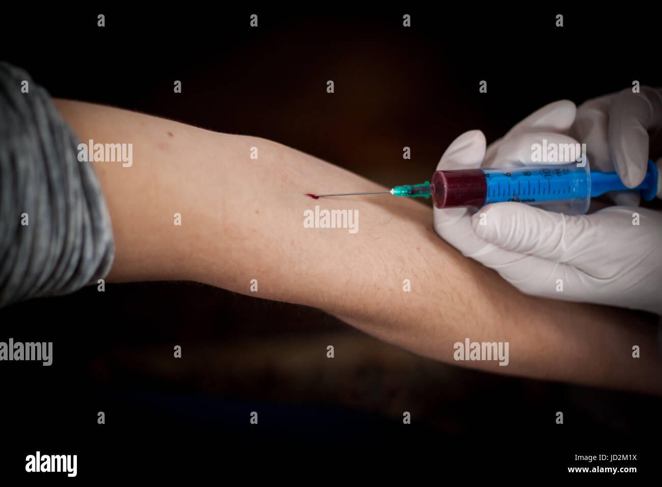 Doctor and patient sitting across from each other, while the doctor ...