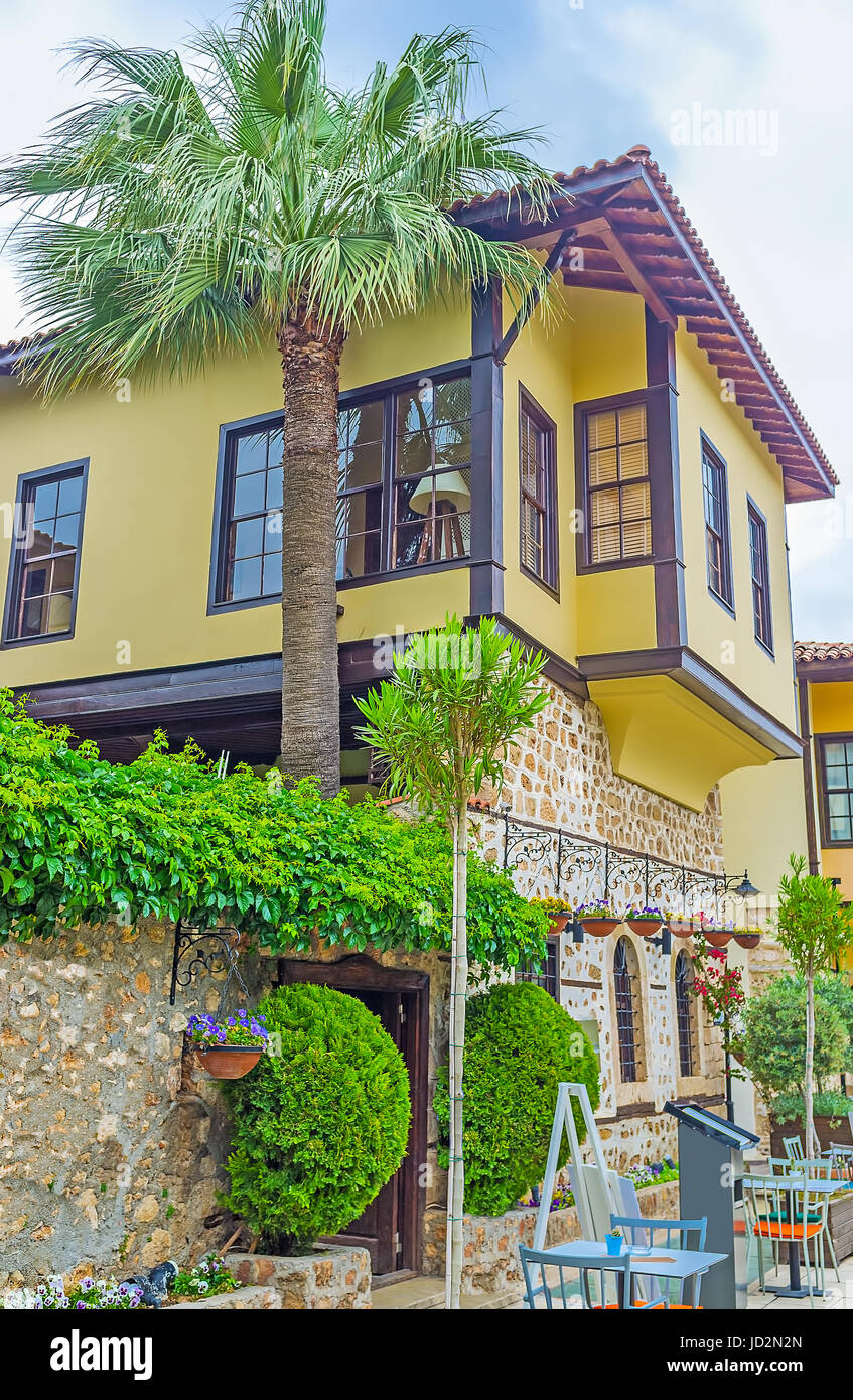 The old Ottoman townhouse with the stone fence and lush garden behind ...