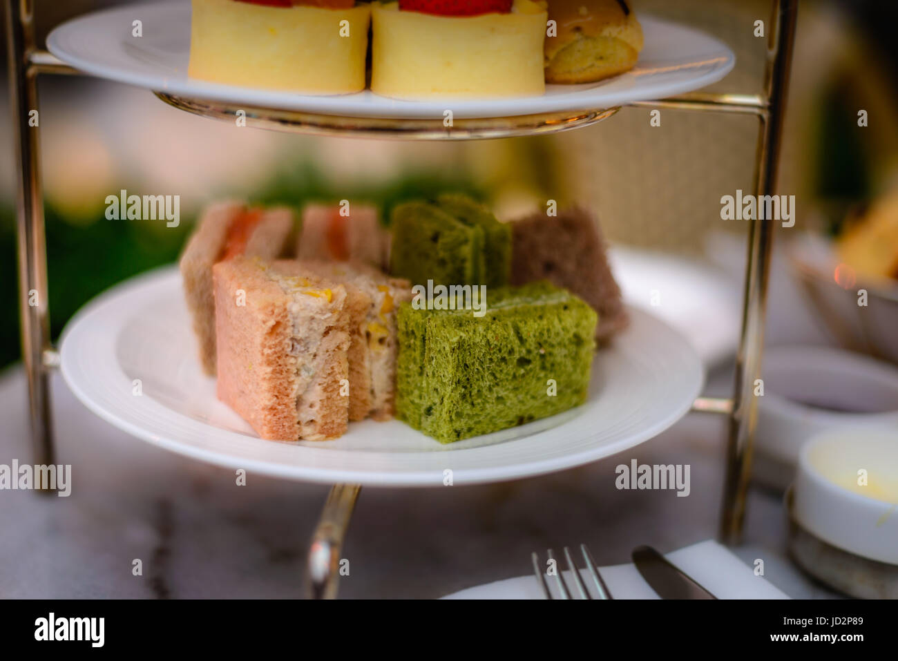 three tier afternoon tea set and pastries Stock Photo - Alamy