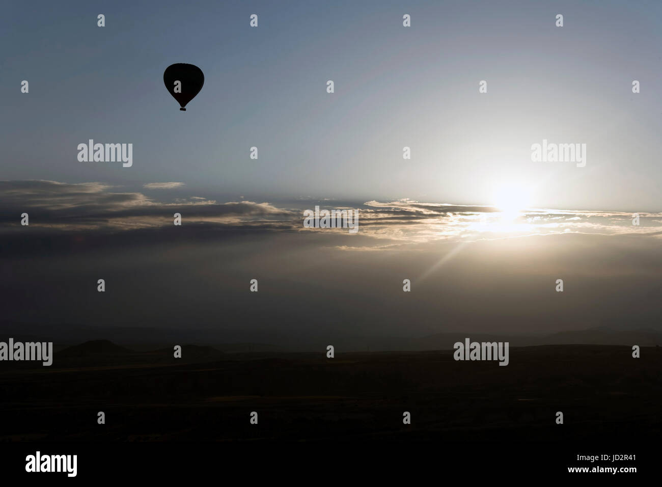 Hot air balloon in the cloudy sky with sunrise Cappadocia, Turkey Stock ...