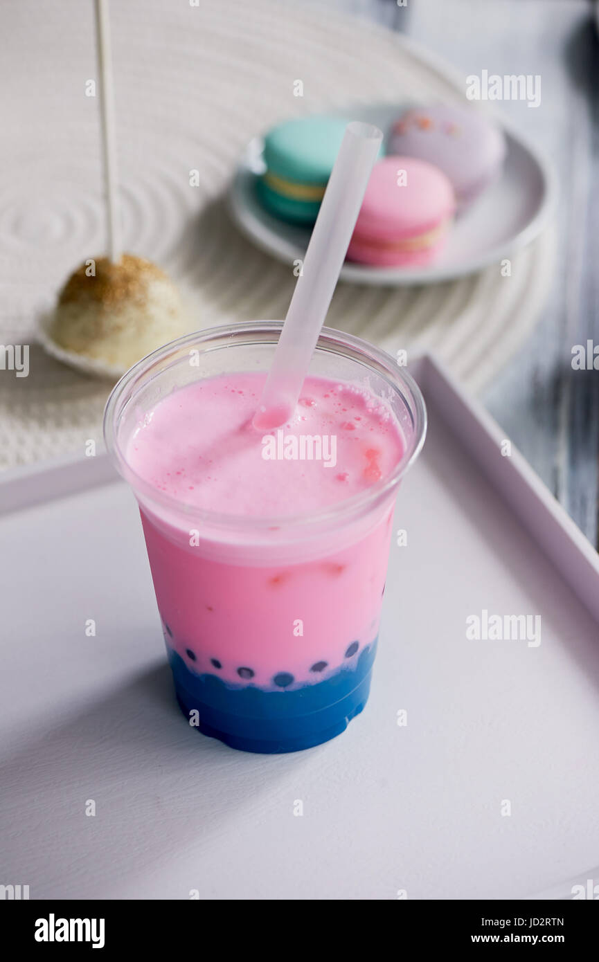 bubble tea in pink and blue color in a plastic Cup with a straw. Soft ...