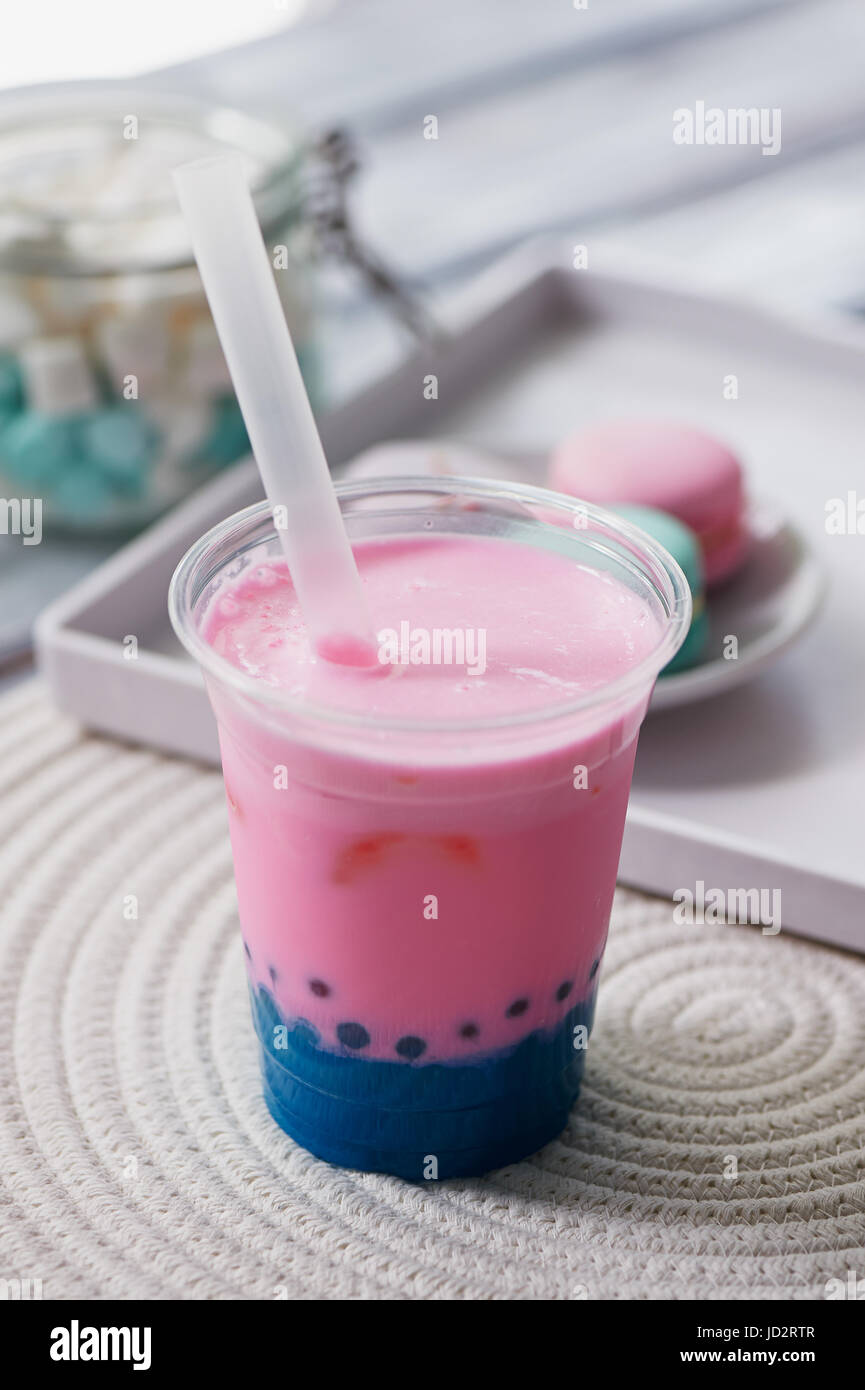 bubble tea in pink and blue color in a plastic Cup with a straw. Soft ...