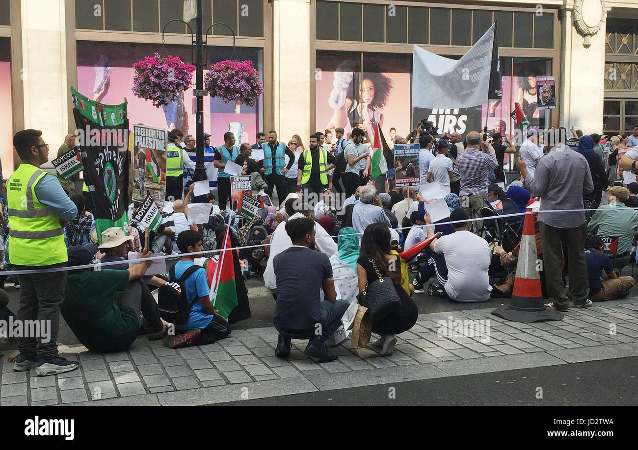 Pro-Palestine supporters staging a sit-down protest on Oxford Street in ...
