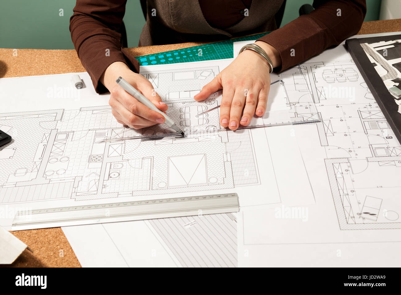 Close up of architect hands working on blueprints Stock Photo - Alamy