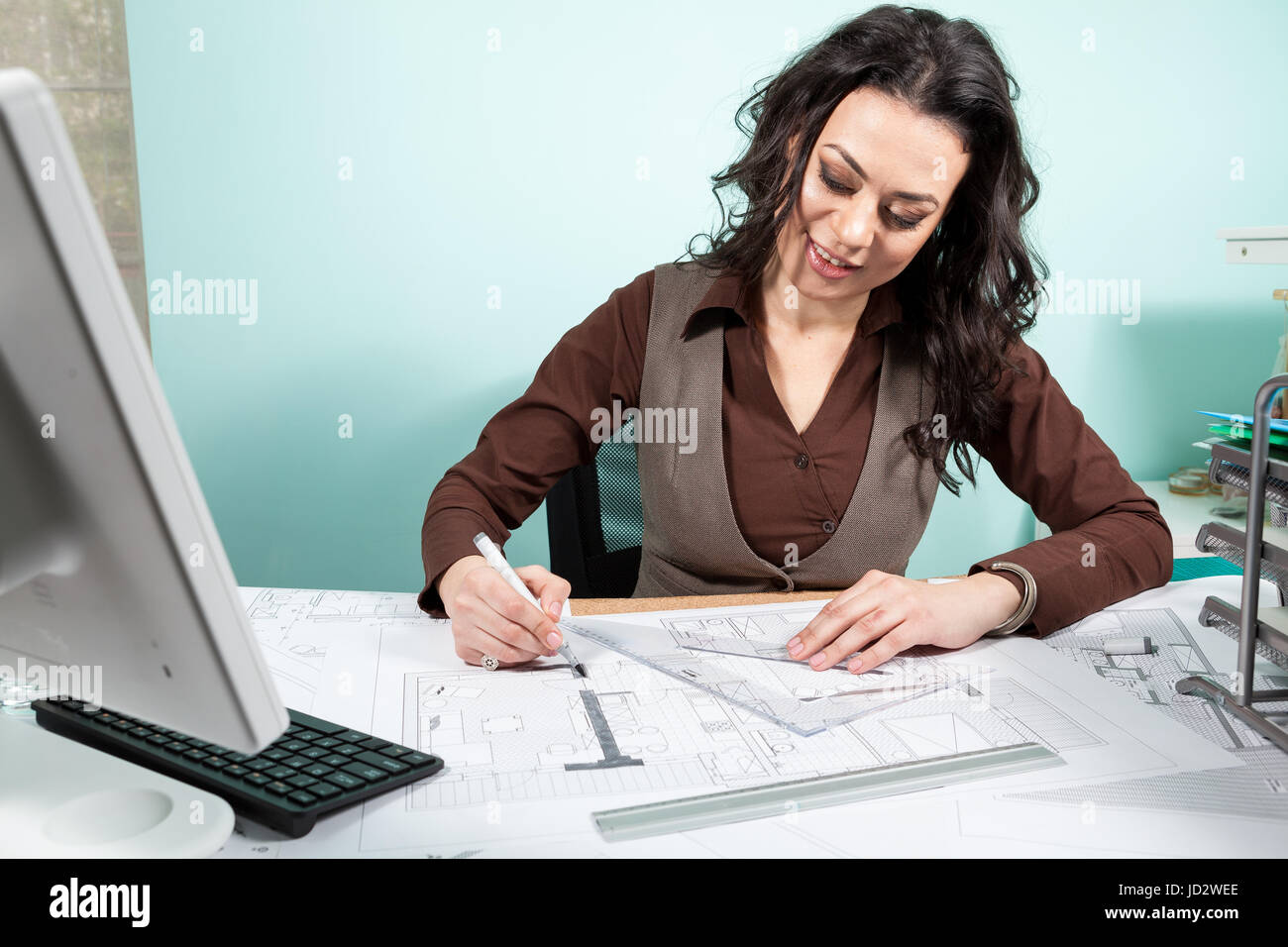 Woman architect working on blueprints Stock Photo - Alamy