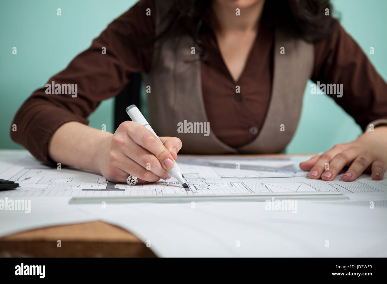 Architect working on blueprints on her desk Stock Photo - Alamy