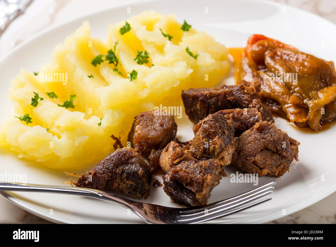 Tochitura Moldoveneasca Romanian traditional food with baked peppers ...