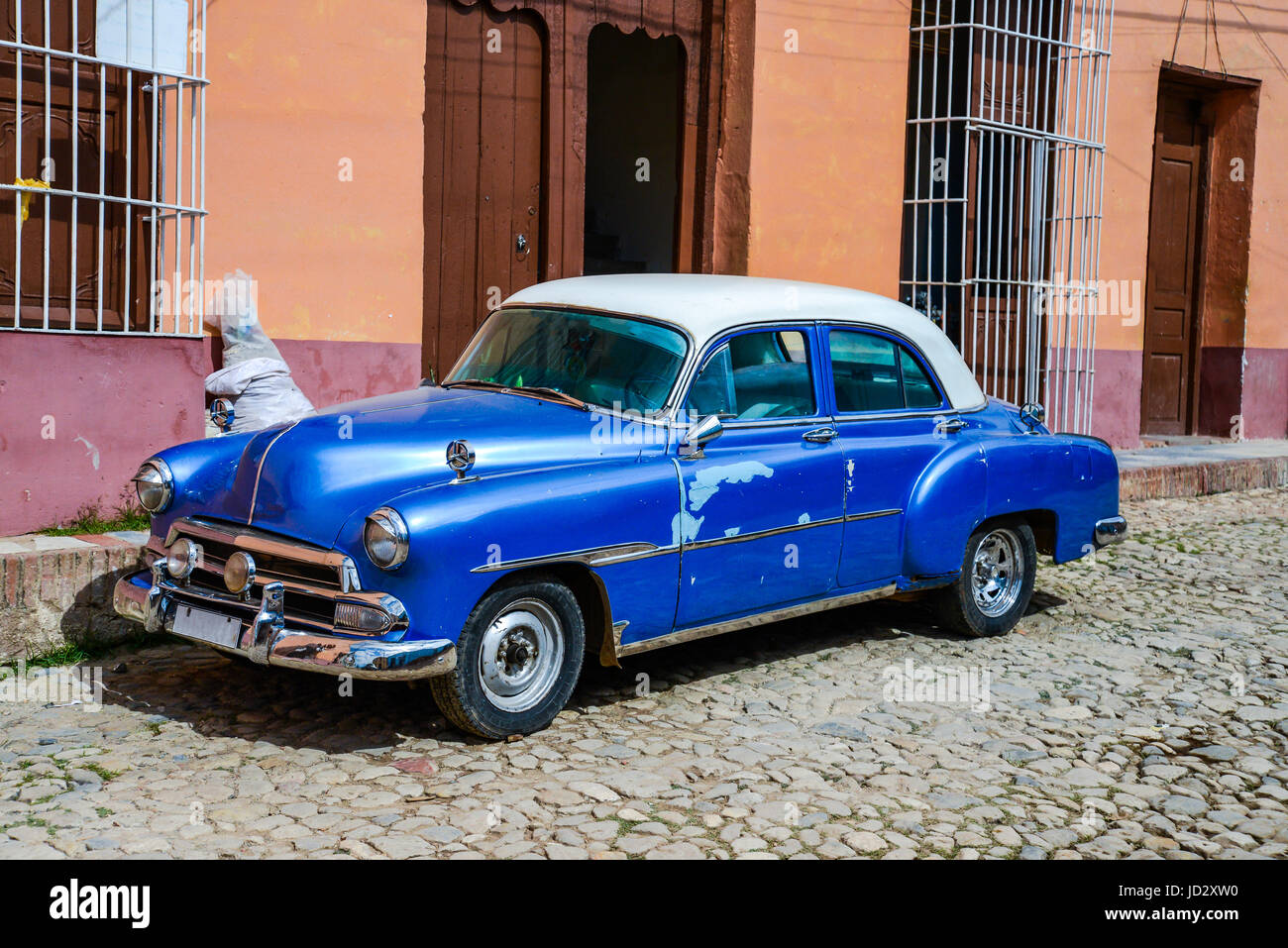 Vibrant vintage car on colonial street in Cuba Stock Photo - Alamy