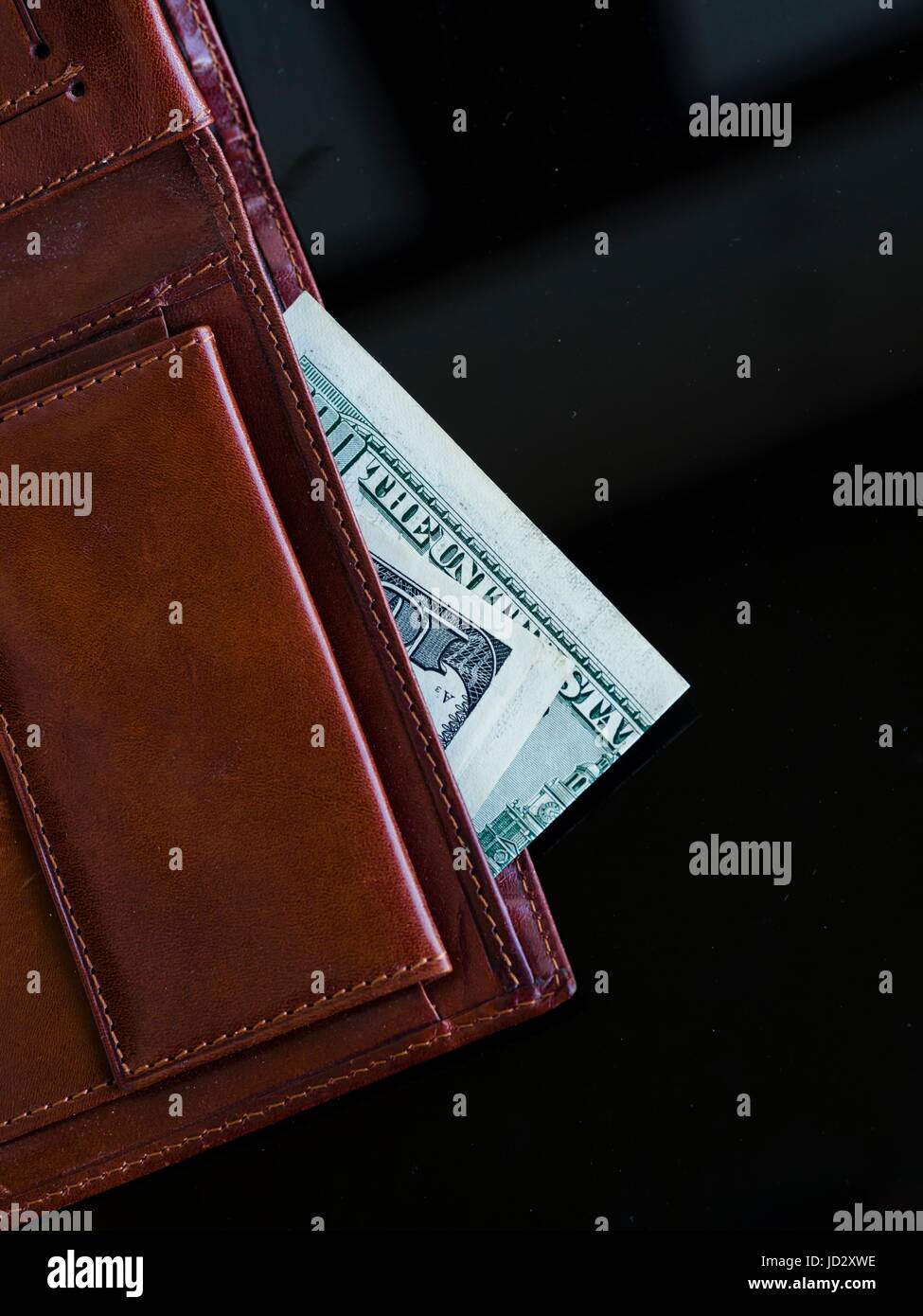 Money in wallet on Black background Stock Photo - Alamy