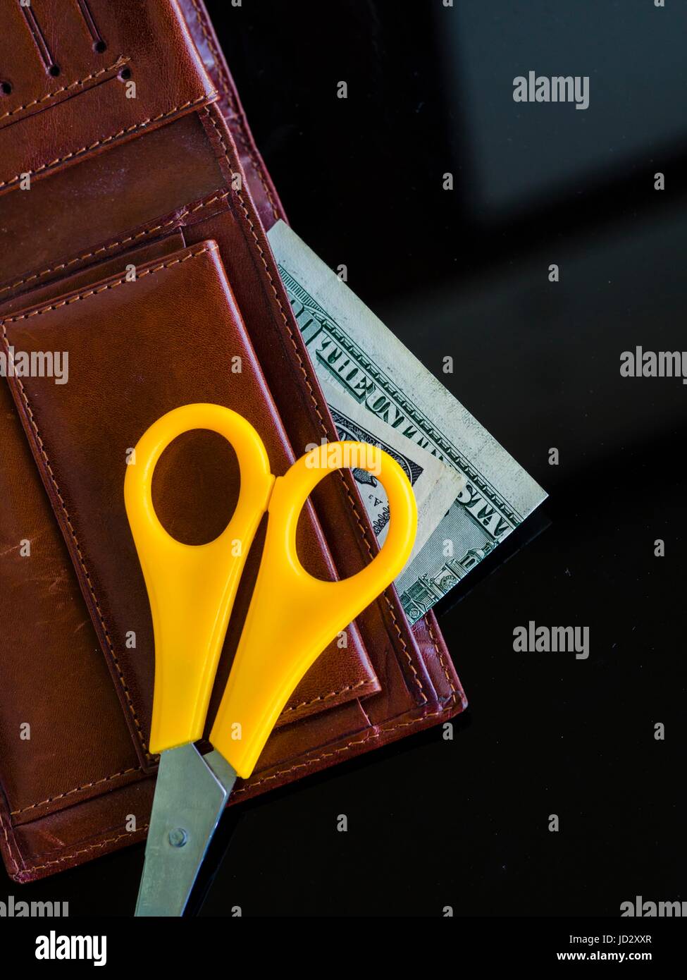 Scissors cutting dollars hi-res stock photography and images - Alamy