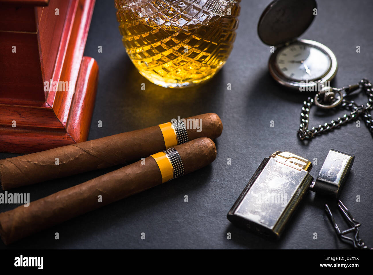 Cuban cigar with lighter and old watch Stock Photo - Alamy
