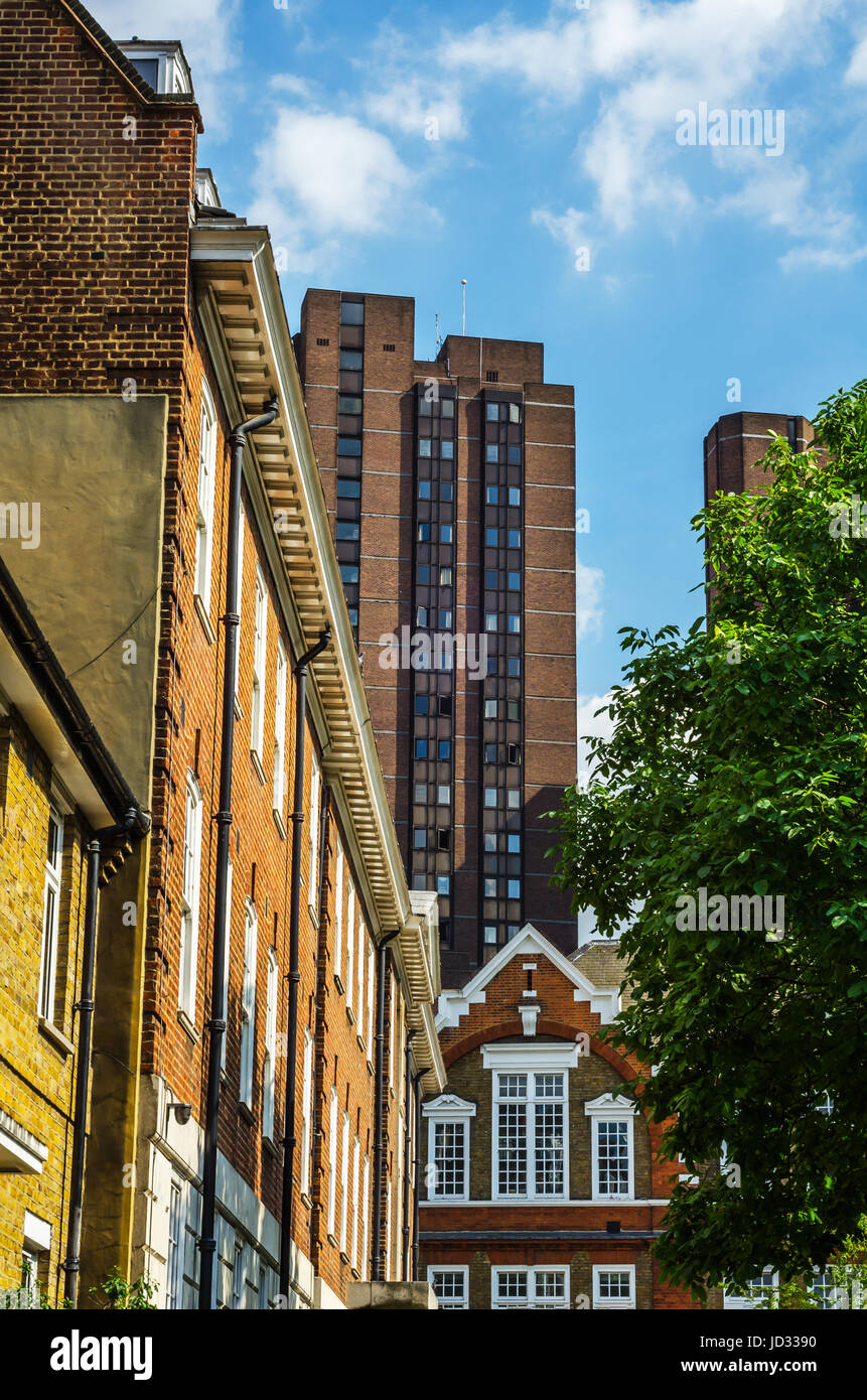 Typical old English buildings, low brick buildings across a narrow ...
