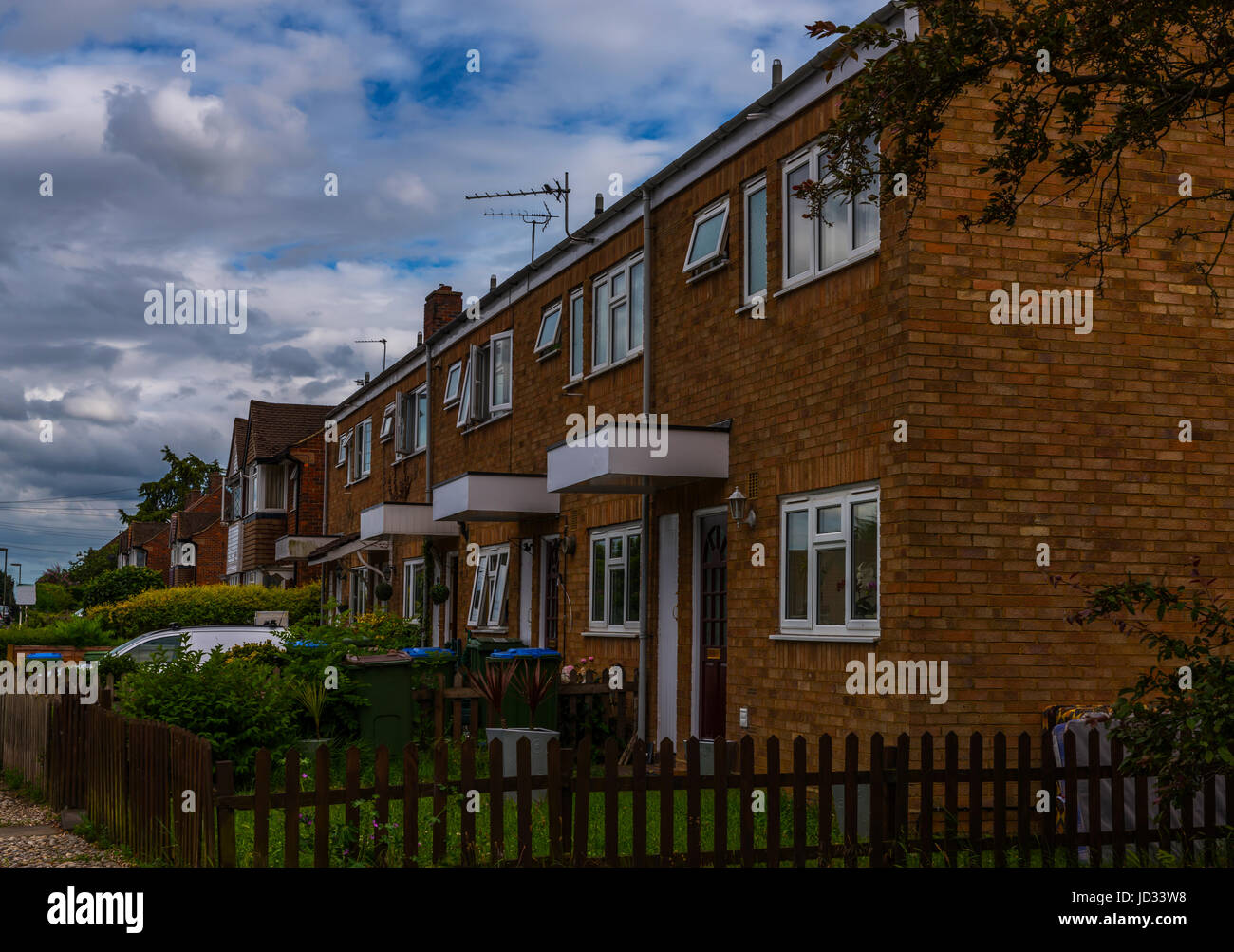 Typical old English buildings, low brick buildings across a narrow ...