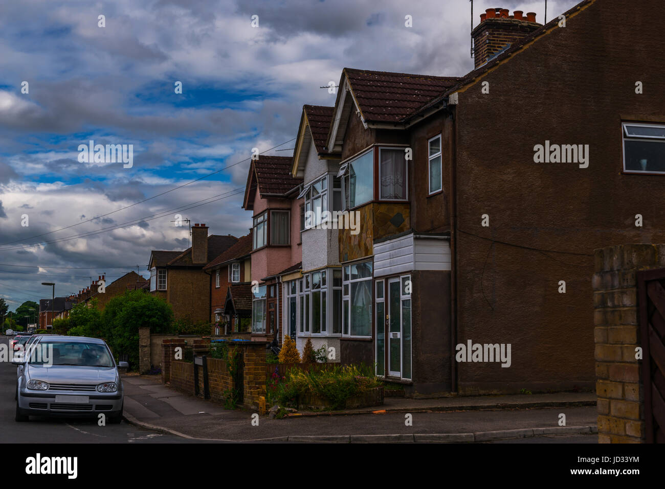Typical old English buildings, low brick buildings across a narrow ...