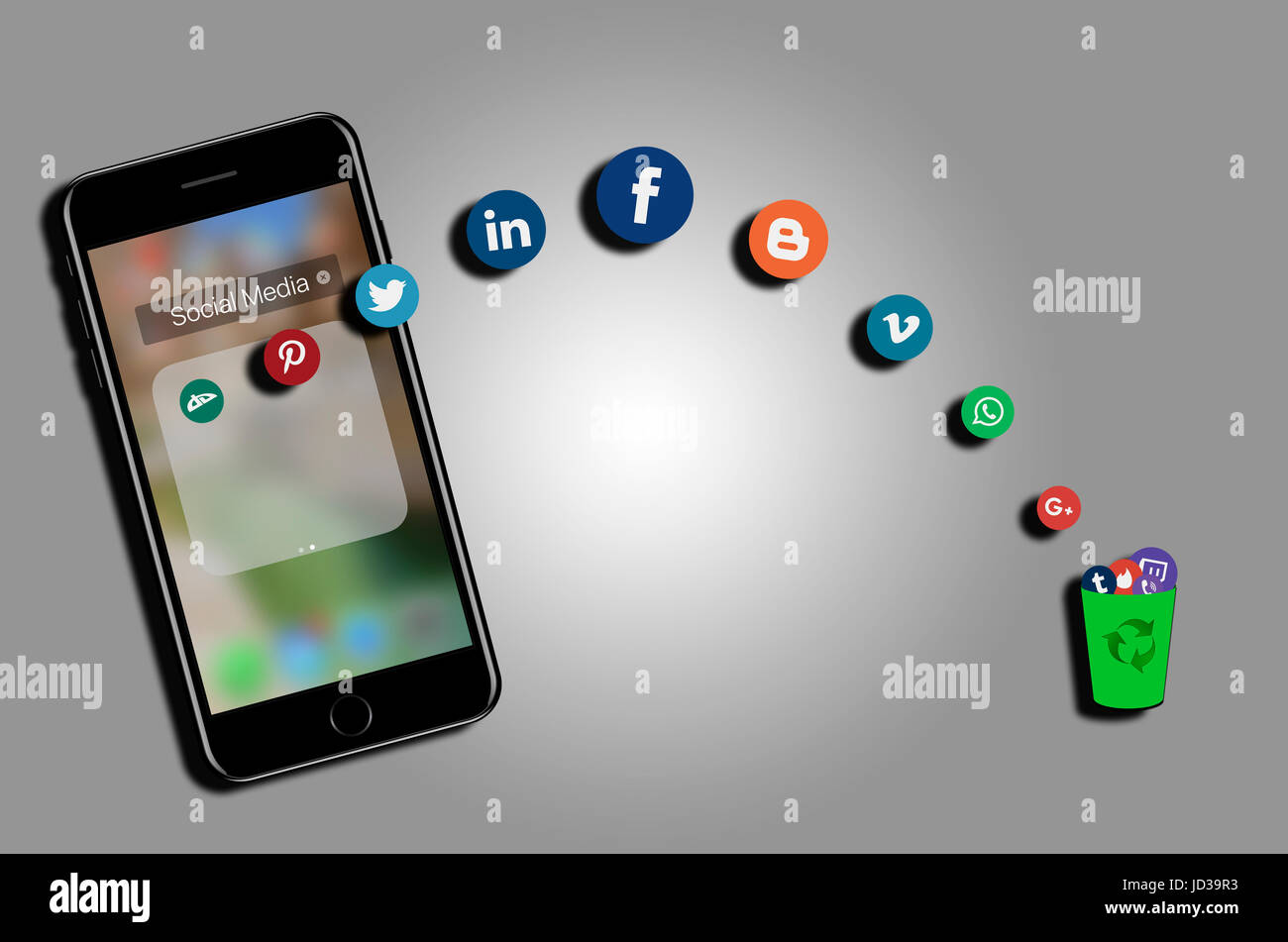 Social media apps falling into a green trash bin on a light grey ...