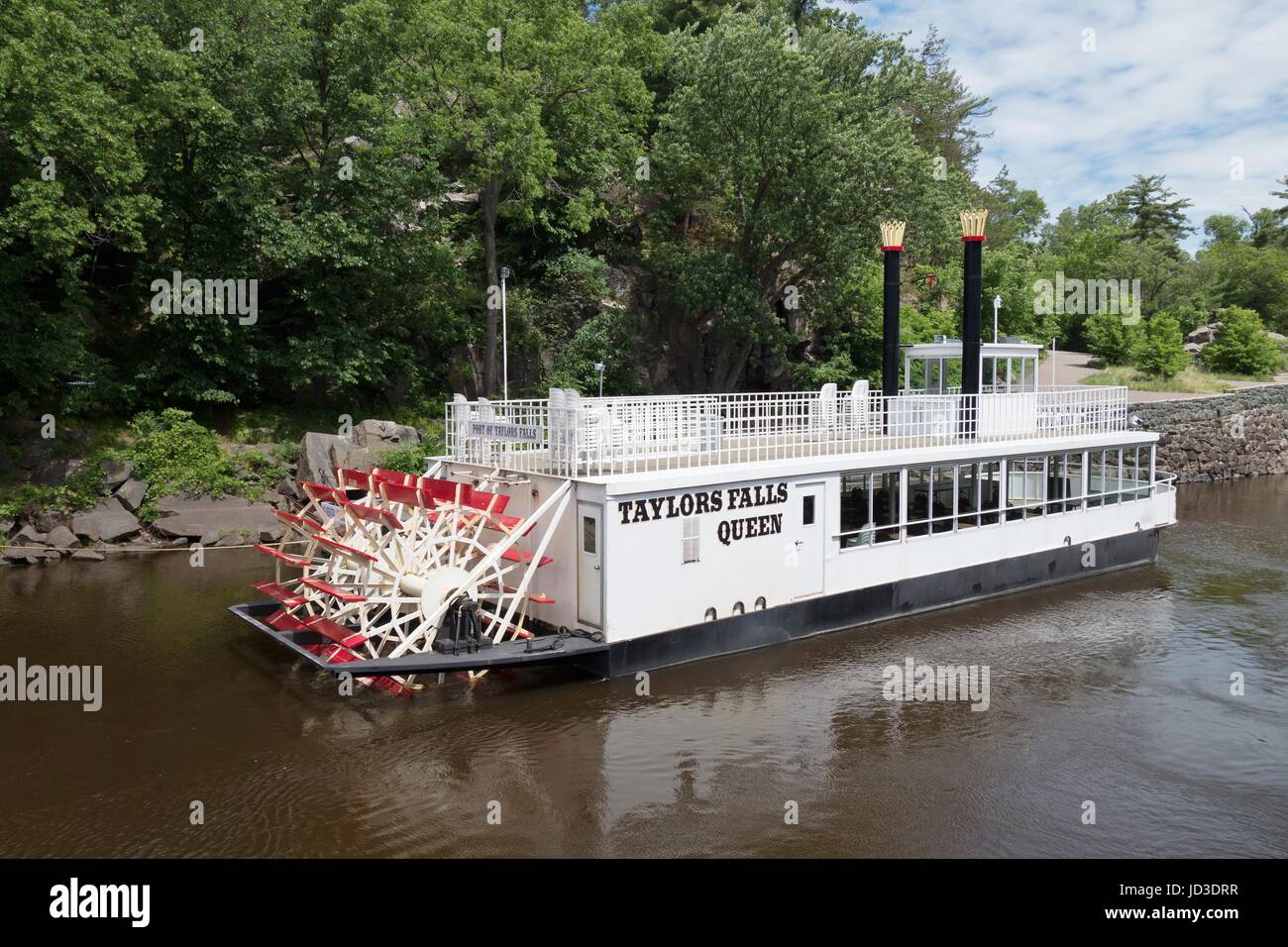 A riverboat, the Taylors Falls Queen, parked on the St. Croix river in Taylors Falls, MN, USA ...