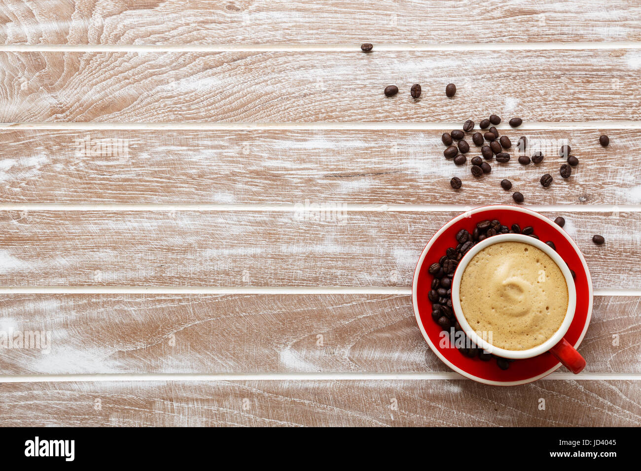 Red cup of coffee with beans on wooden office table background top view ...