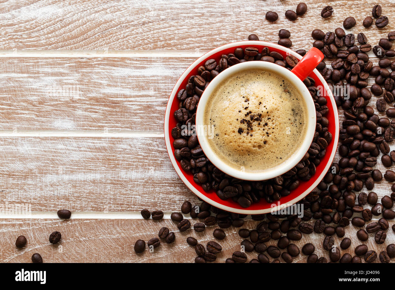 Red cup of coffee with beans on wooden table background top view Stock ...