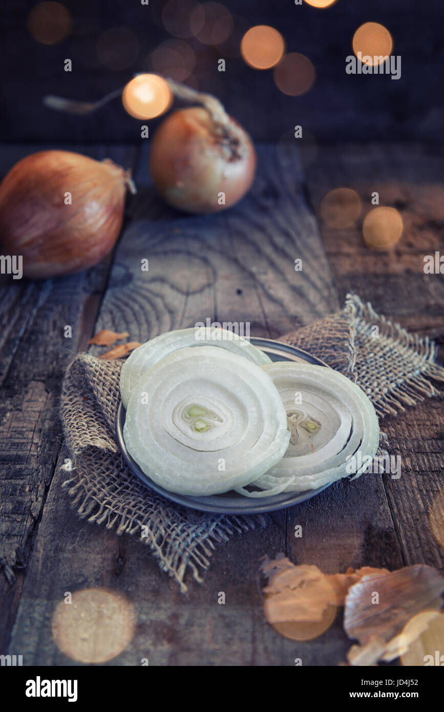 Onion sliced on the rustic wood aces table Stock Photo - Alamy