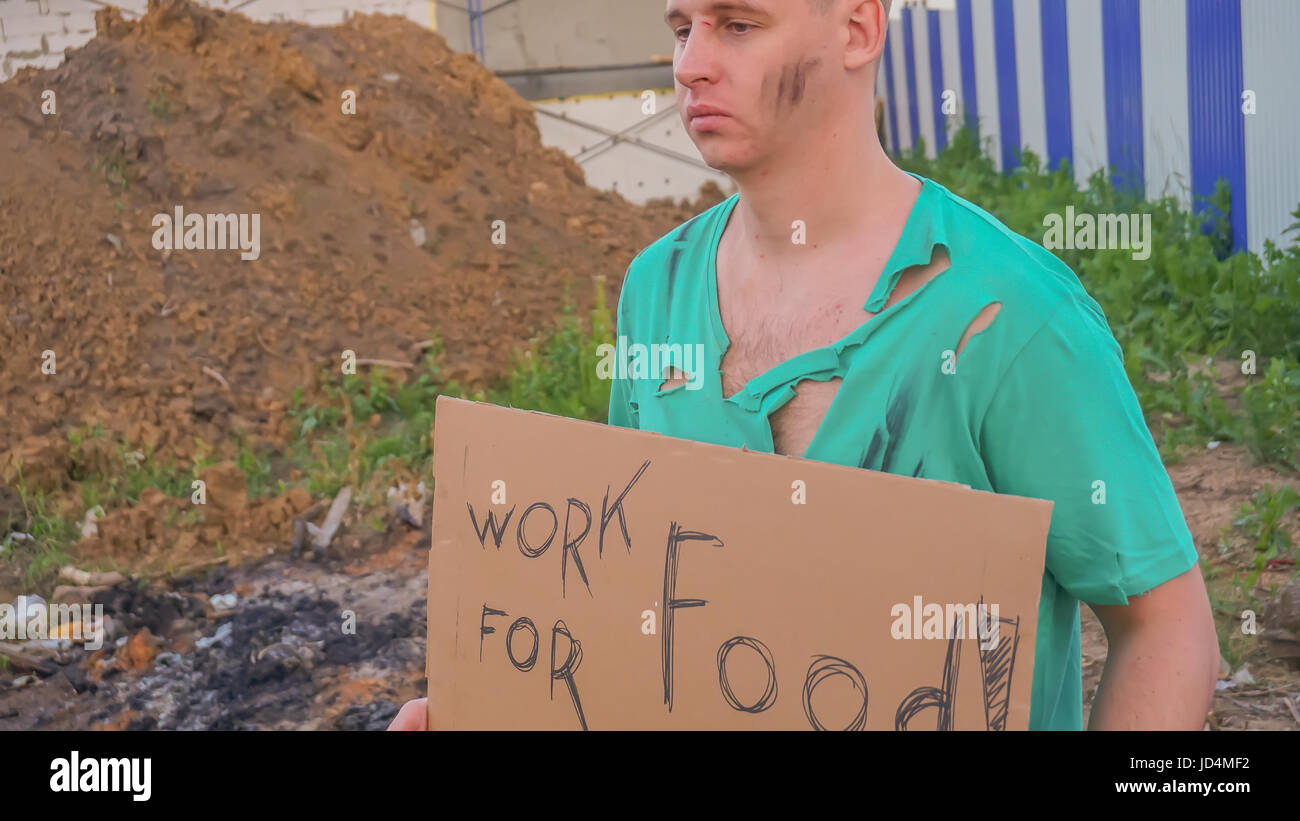 homeless with a sign in hand : work for food Stock Photo - Alamy