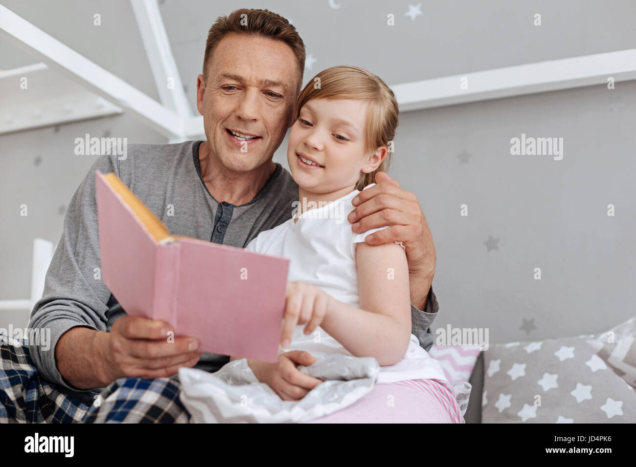 Nice loving man putting his child to sleep Stock Photo - Alamy