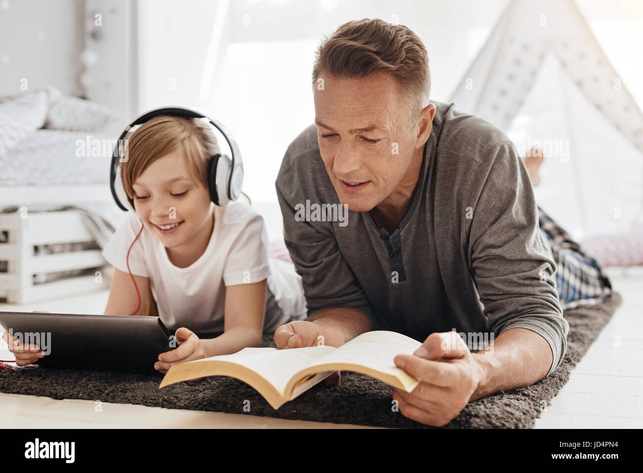 Enthusiastic father and daughter enjoying their hobbies together Stock ...