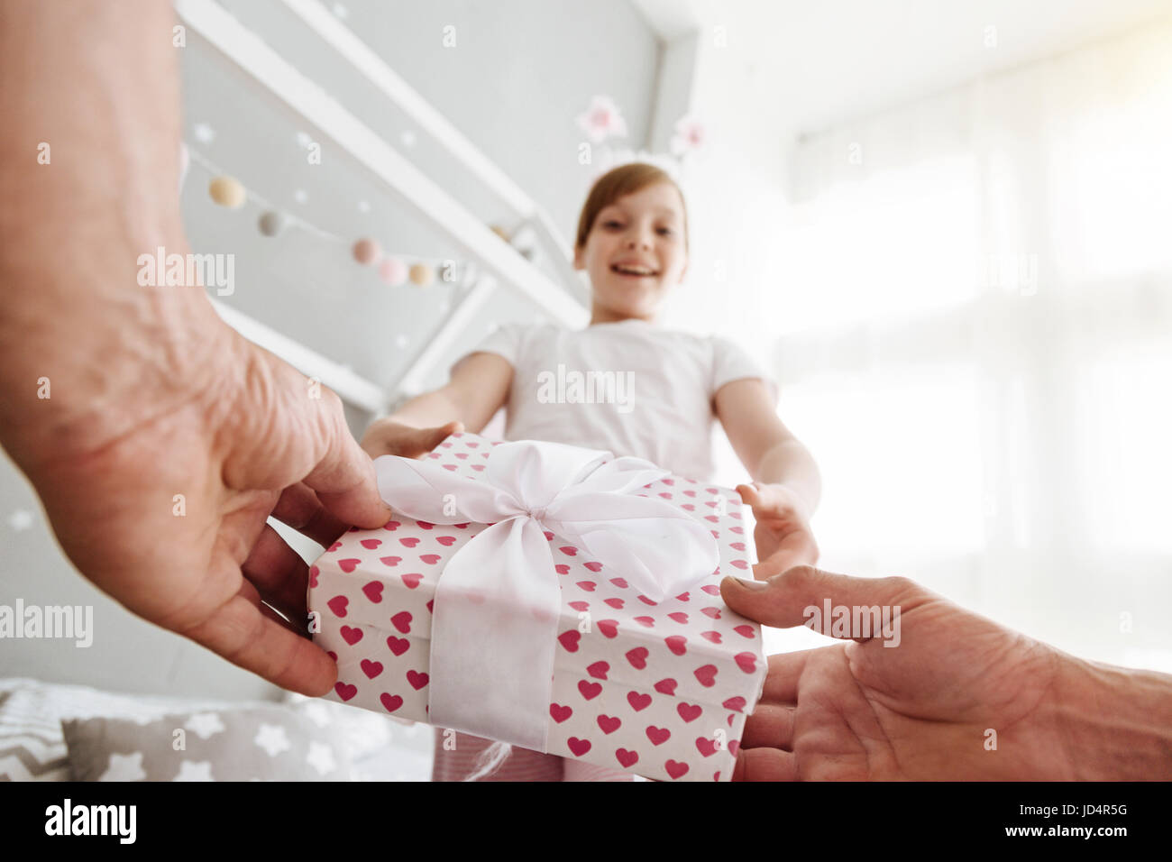 Attentive lovely parent giving his child a present Stock Photo - Alamy