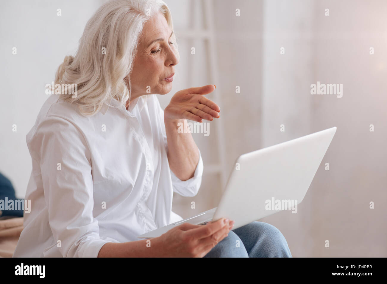 Joyful cheerful woman throwing a kiss Stock Photo - Alamy