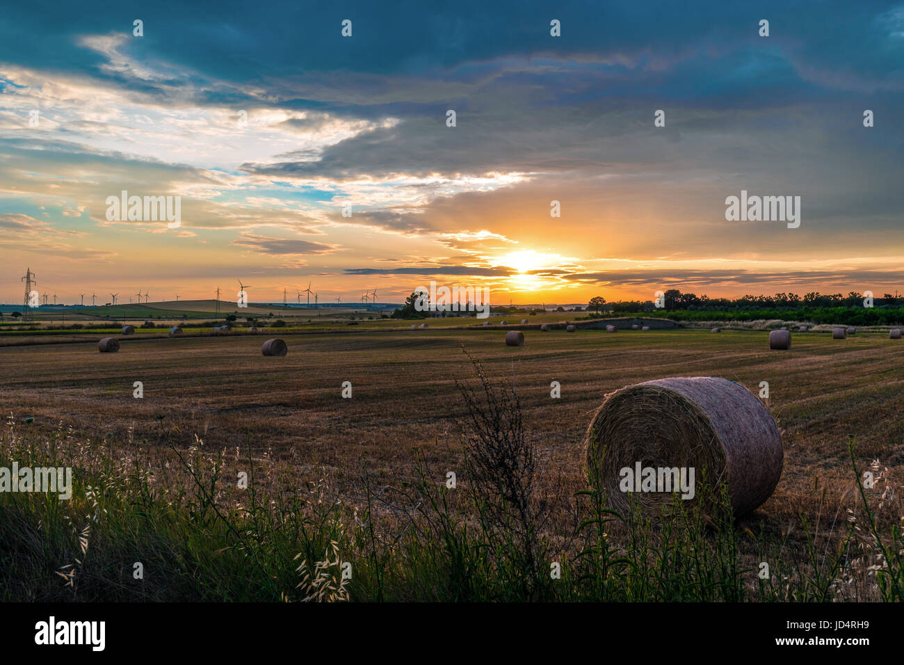 Puglia (Italy) - Wind farm with rock ruins, wind turbines and bales of ...